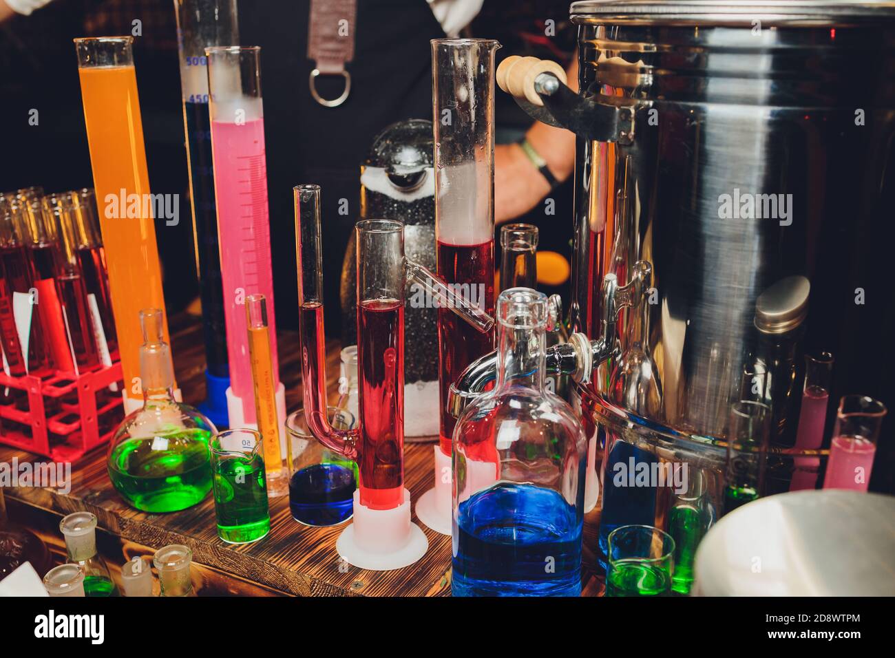 Test tubes with multi-colored liquid. Alcohol in test tubes dark bar ...
