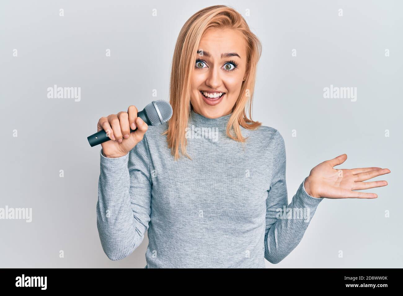Beautiful caucasian woman singing song using microphone celebrating ...