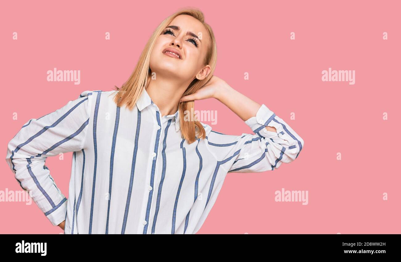 Beautiful caucasian woman wearing casual clothes suffering of neck ache ...