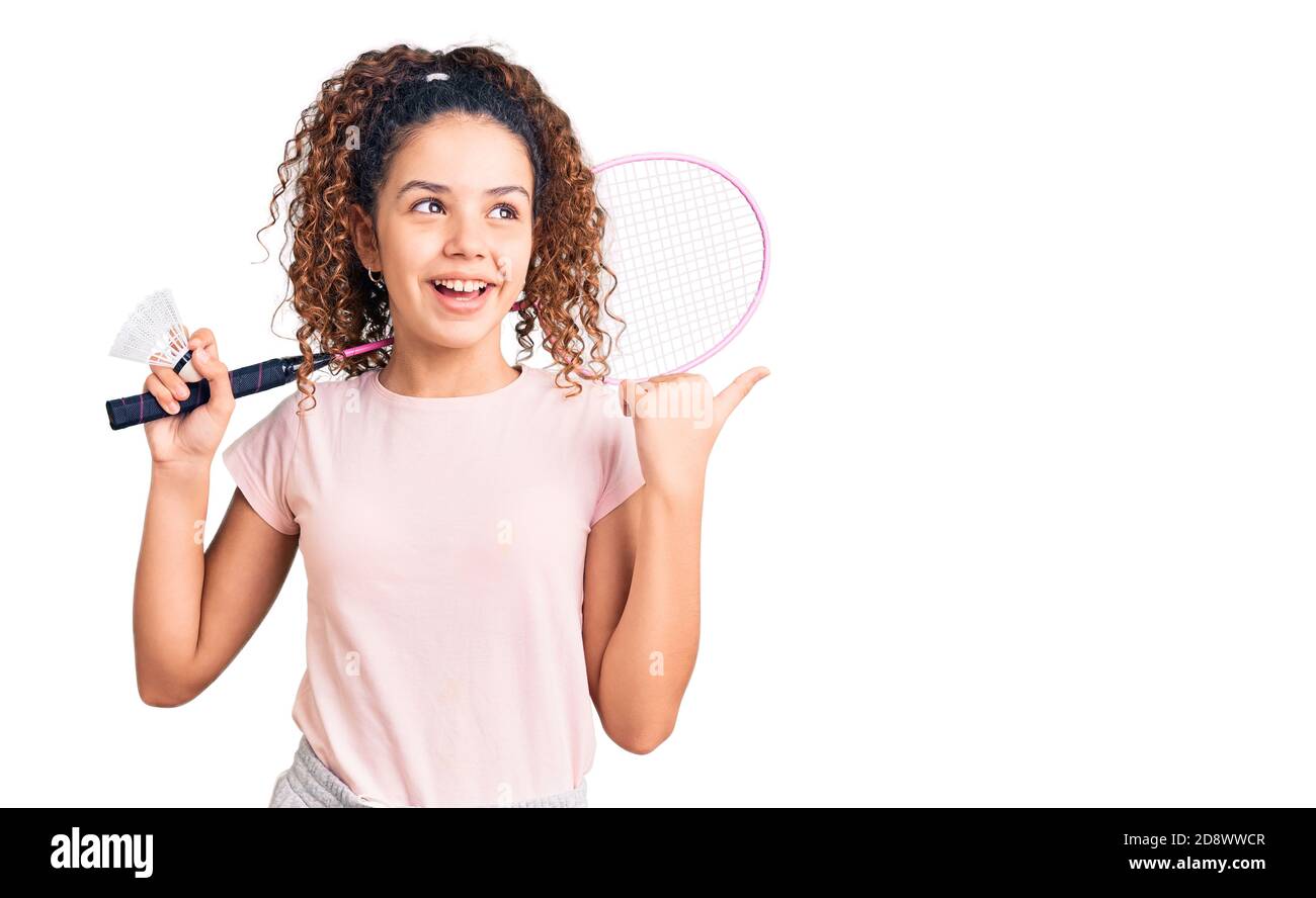 Beautiful kid girl with curly hair holding badminton racket and ...