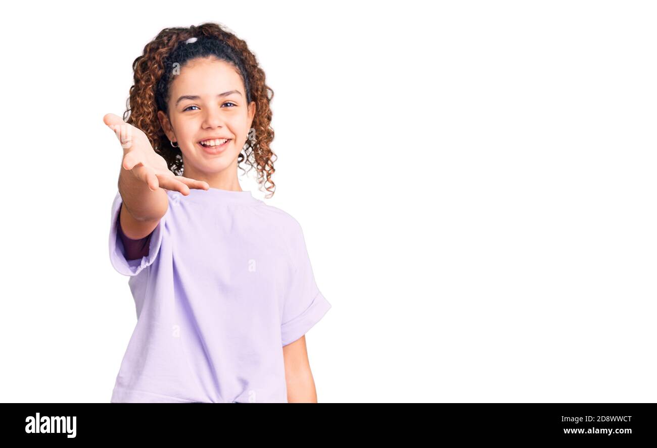 Beautiful kid girl with curly hair wearing casual clothes smiling ...