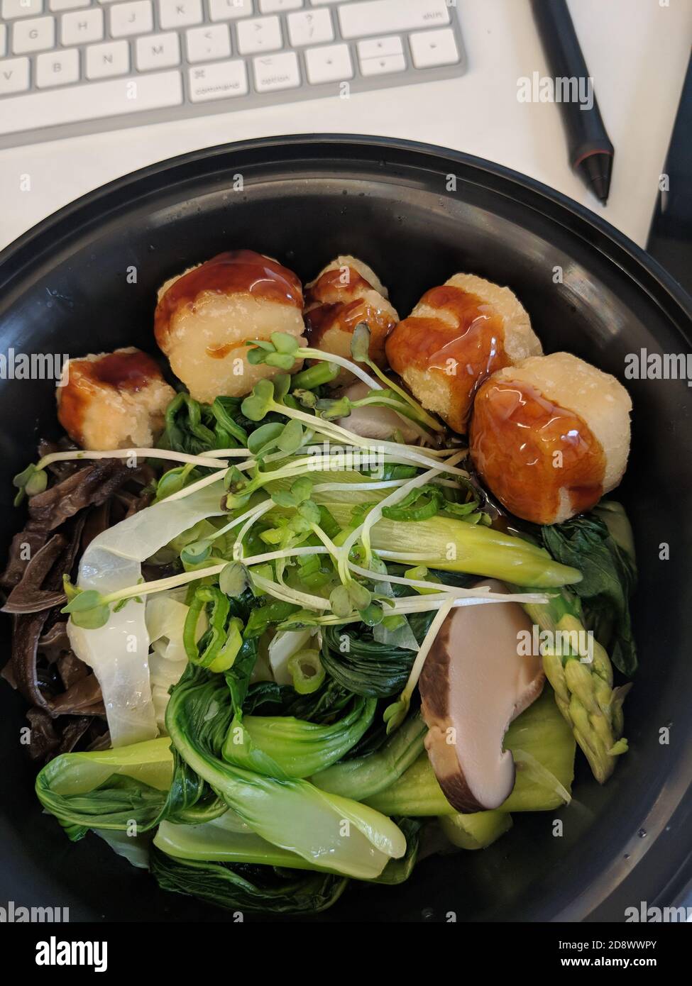 Ramen on a container on a desk with keyboard. Bok Choy. Mushrooms ...