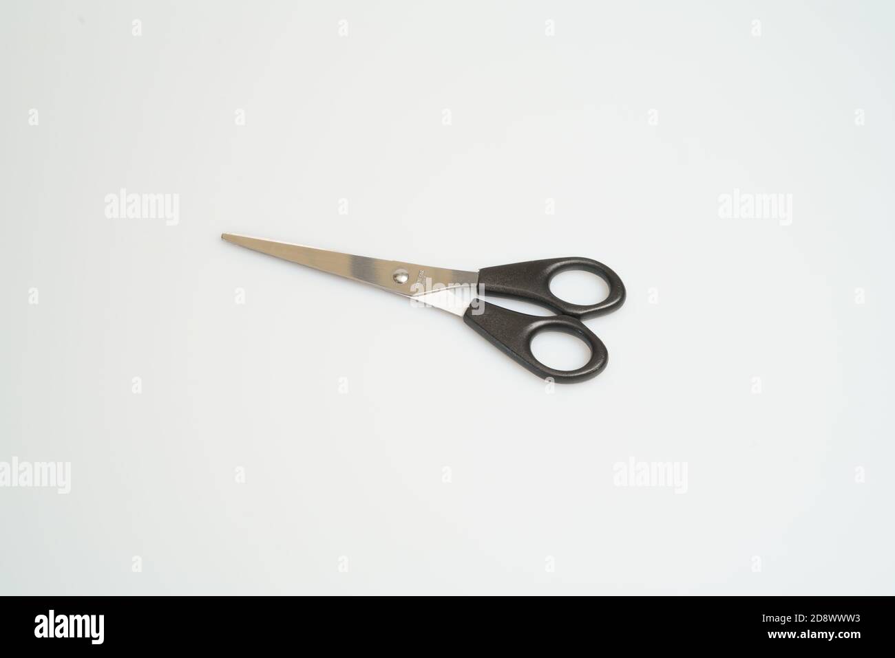 stainless steel scissors with black handle laid Stock Photo - Alamy