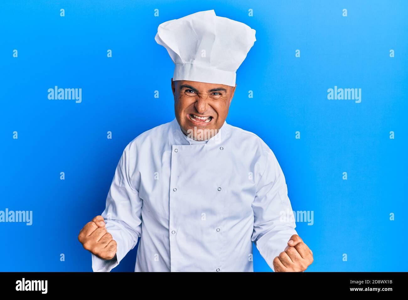 Mature middle east man wearing professional cook uniform and hat very ...