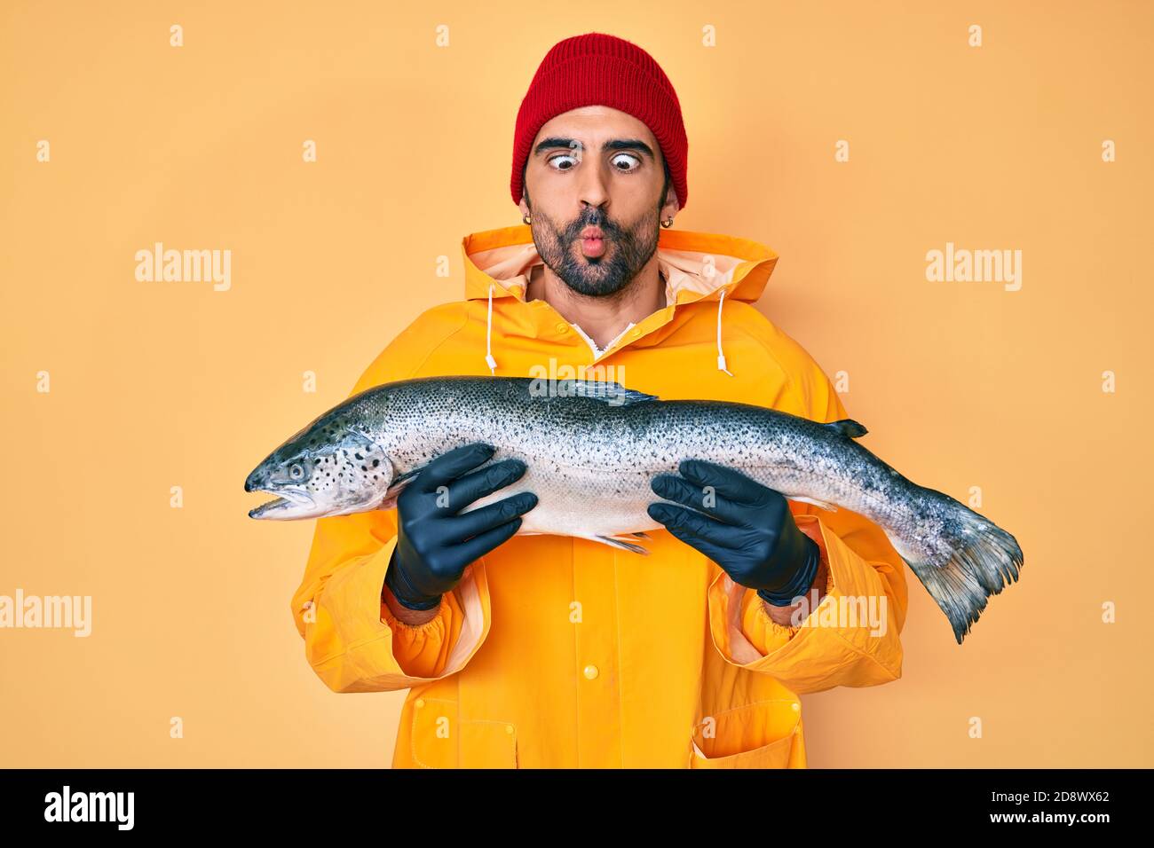 Handsome hispanic man with beard wearing fisherman equipment making ...