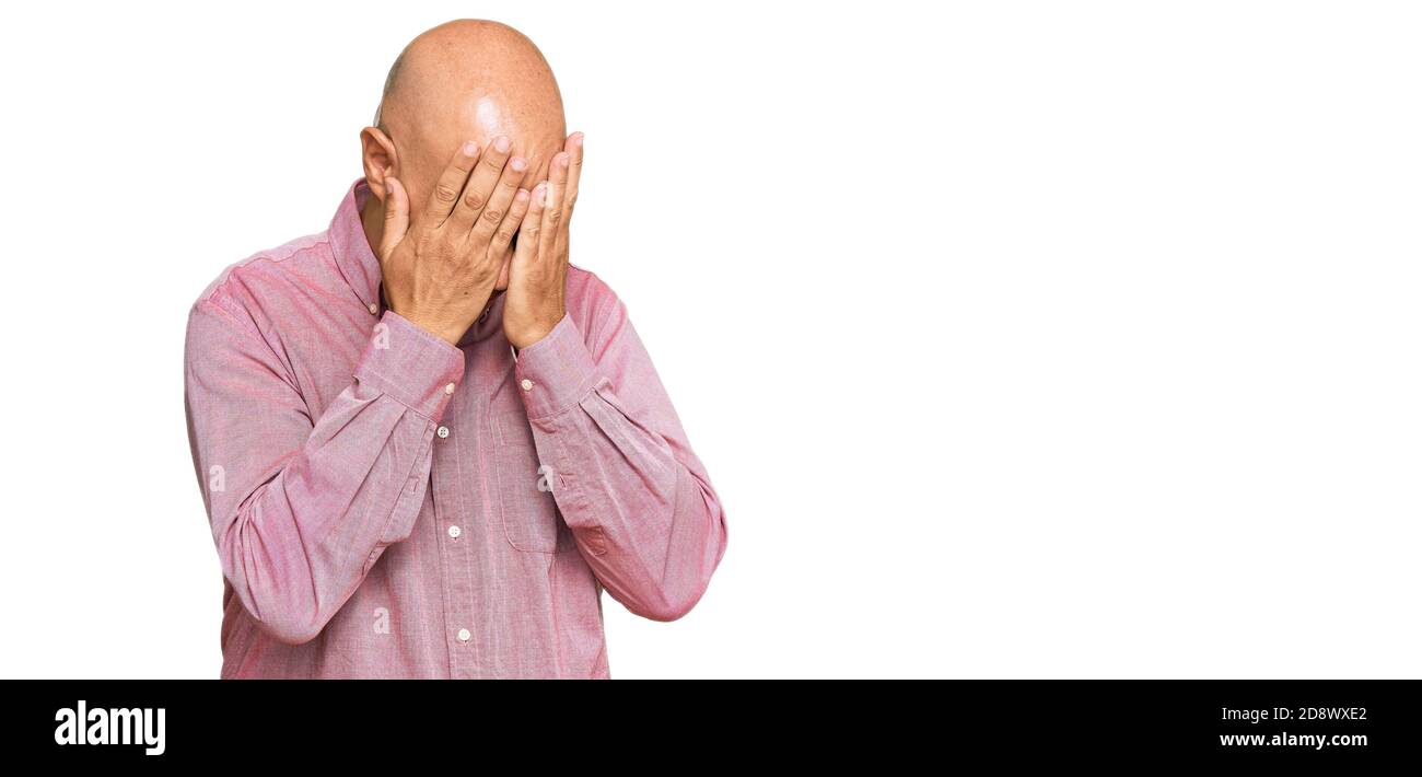 Middle age bald man wearing casual clothes with sad expression covering ...