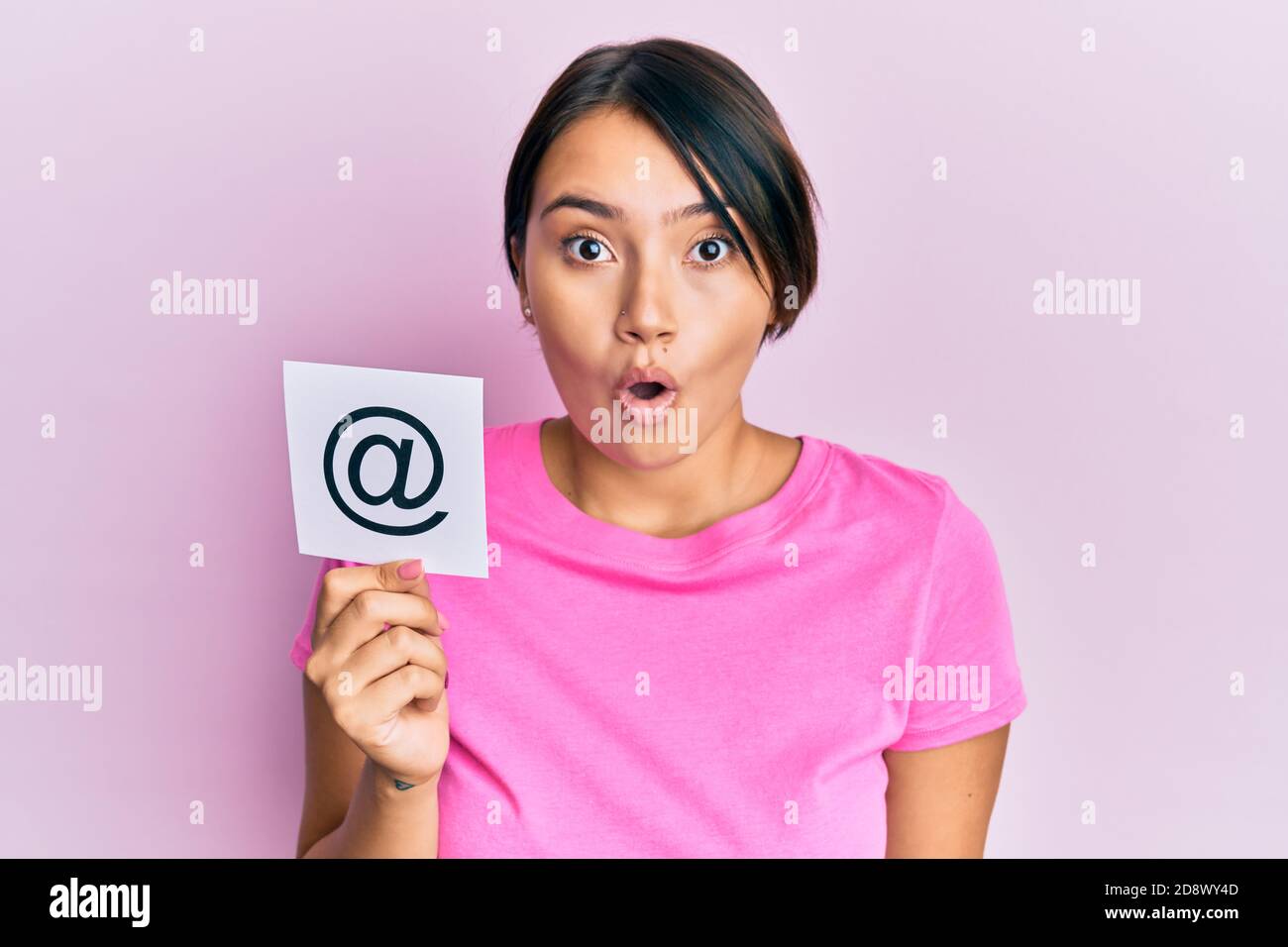 Beautiful young woman with short hair holding paper with email symbol ...