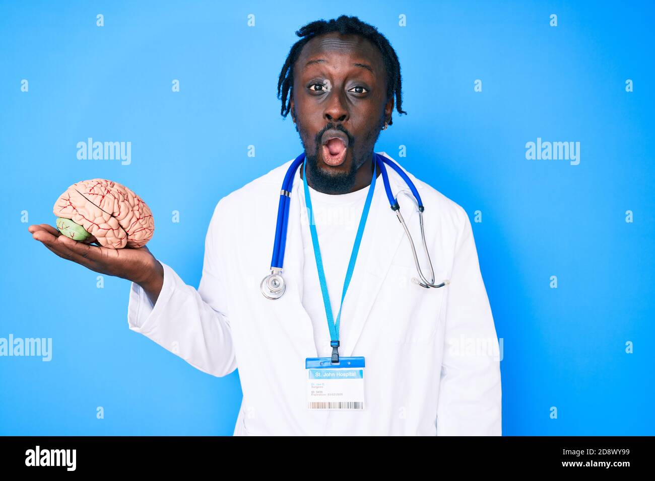 Young african american man with braids wearing doctor coat holding ...