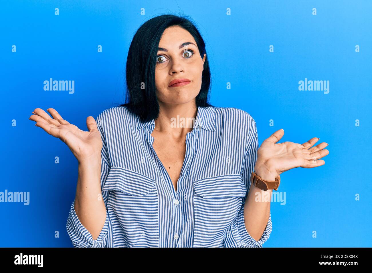 Young caucasian woman wearing casual clothes clueless and confused with ...
