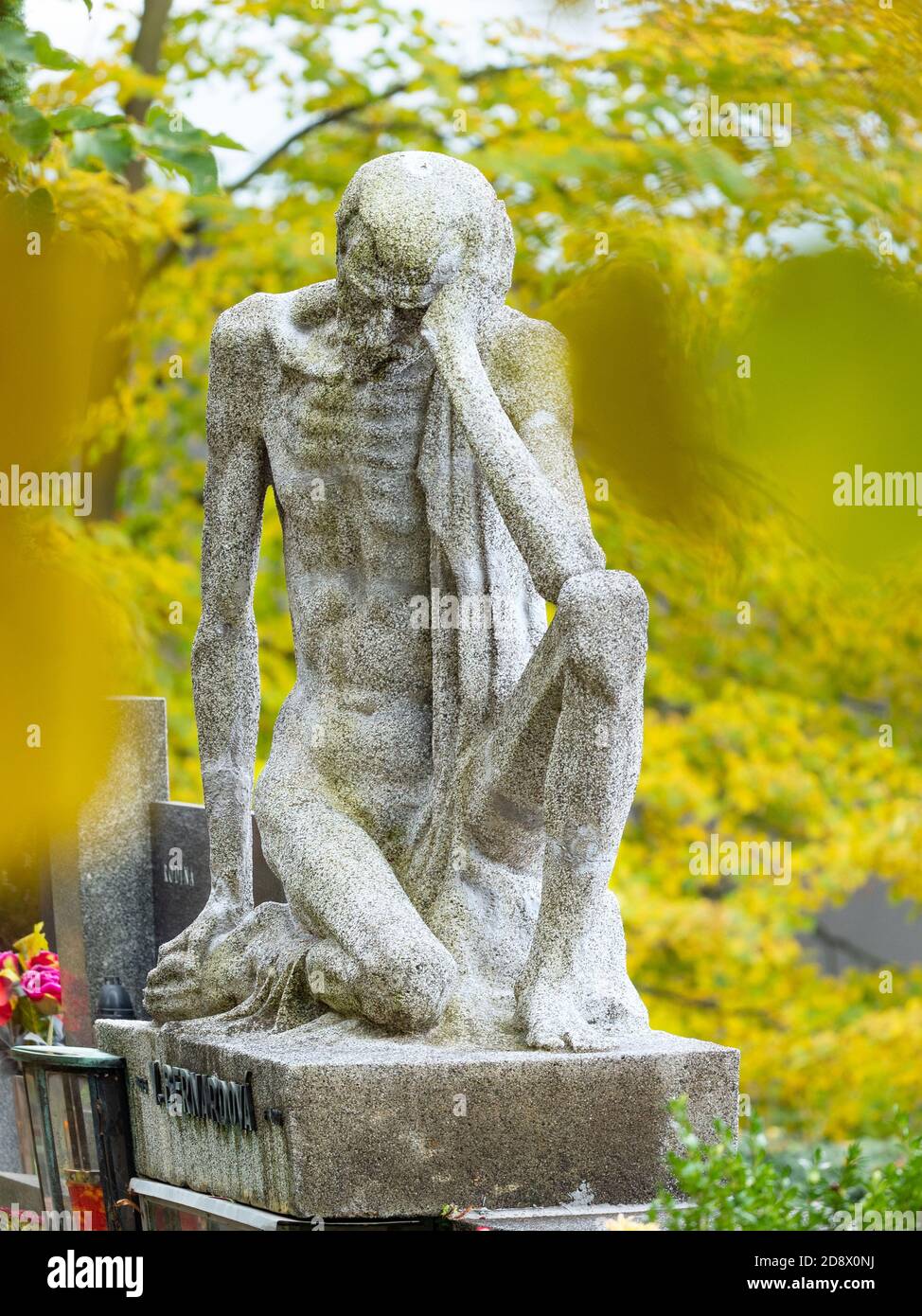 Skinny old man, male granite statue sitting on a tombstone. 24th of ...