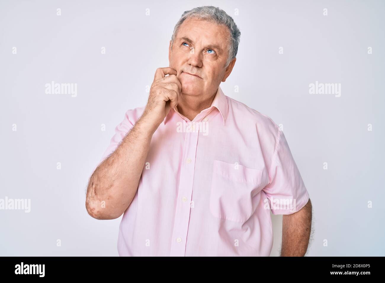 Senior grey-haired man wearing casual clothes thinking concentrated ...