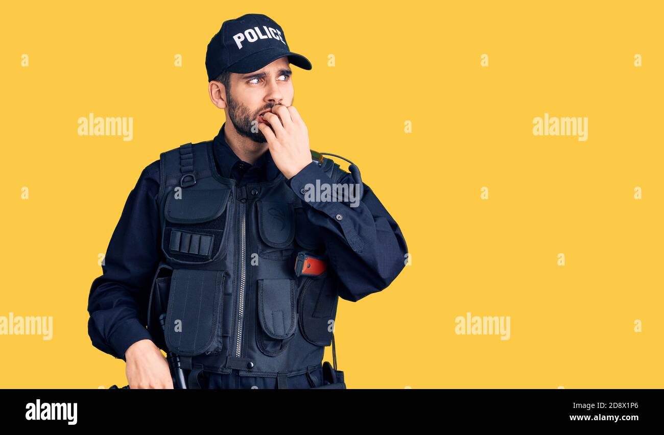 Young handsome man with beard wearing police uniform looking stressed ...
