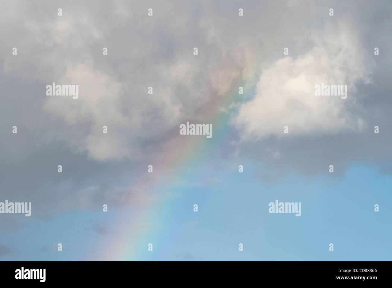 Cumulus cloud and rainbow Stock Photo - Alamy