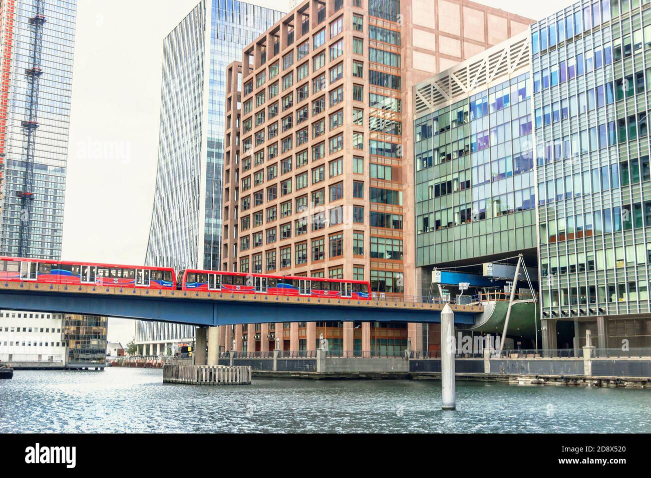 DLR train above water with modern buildings in Canary Wharf Stock Photo ...