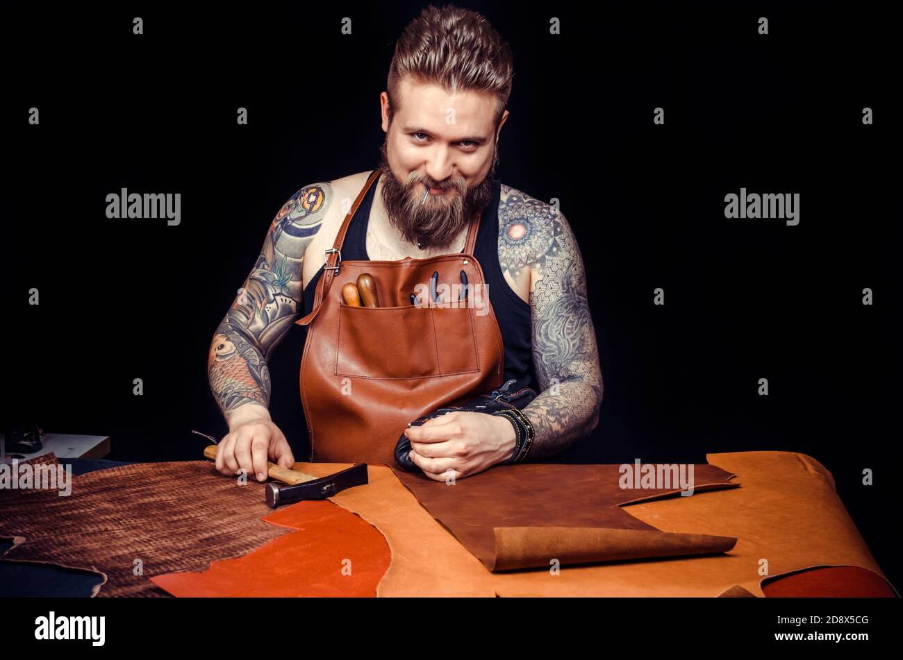 Leather Craftsman producing a leatherwork at his desk Stock Photo - Alamy