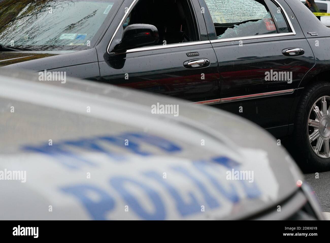 A cab riddled with bullets seen at a crime scene in Corona.Passenger in ...
