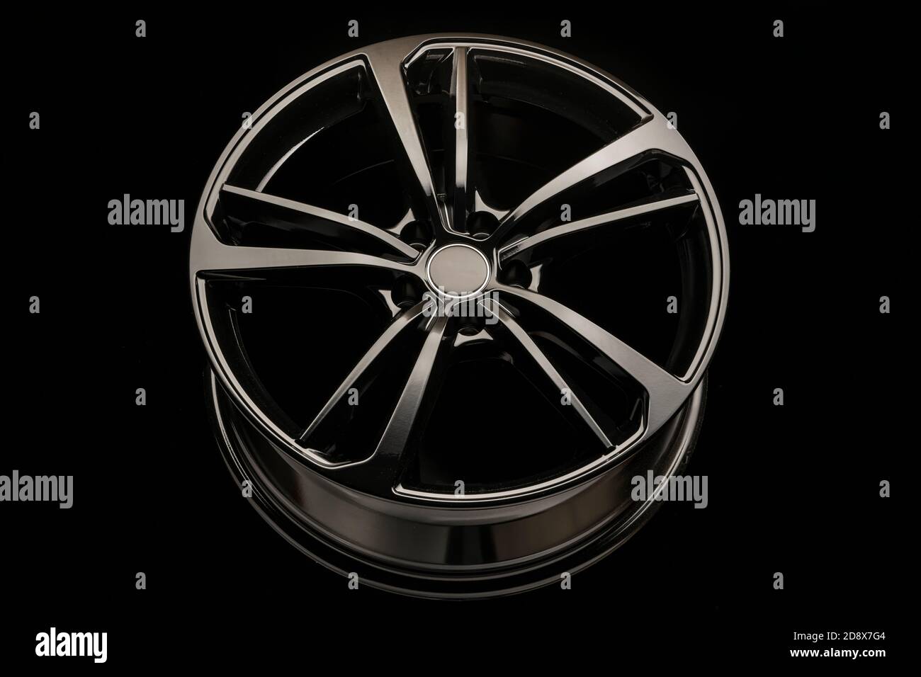 black stylish rim alloy wheel on a dark background. close-up, front ...