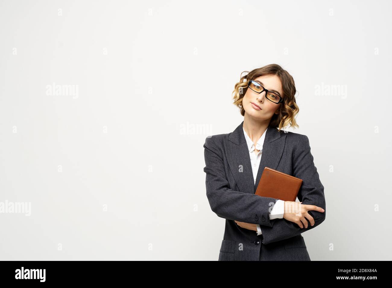 Business woman with notepad and glasses work light background cropped ...