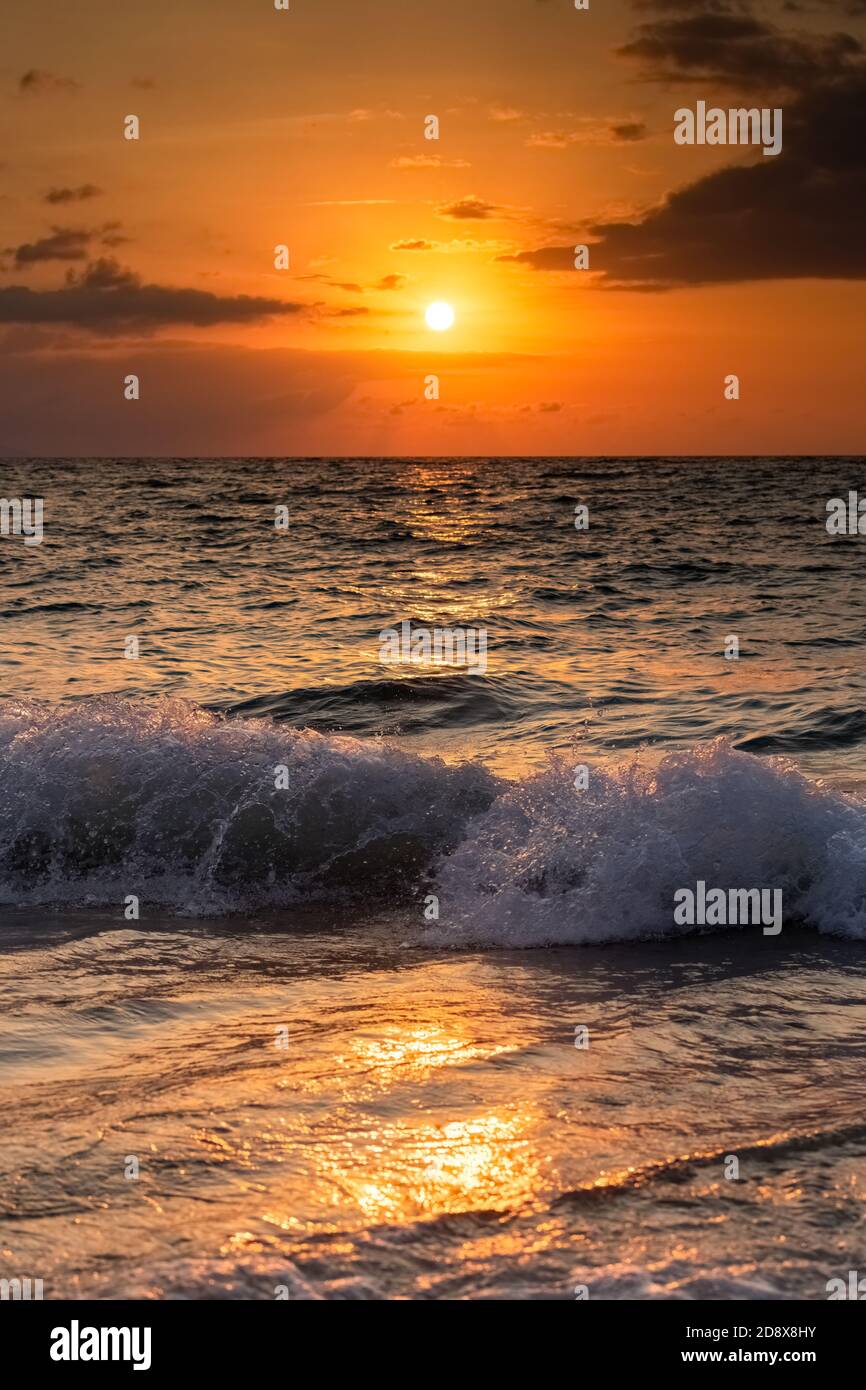 A Vertical Images of an Ocean Sunset with a Wave Breaking in the ...