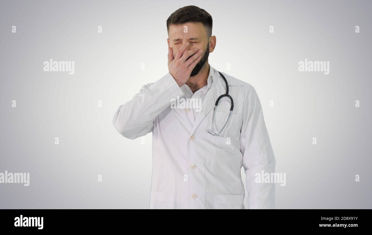 Medium shot. Tired turk doctor holding face in despair on gradient ...