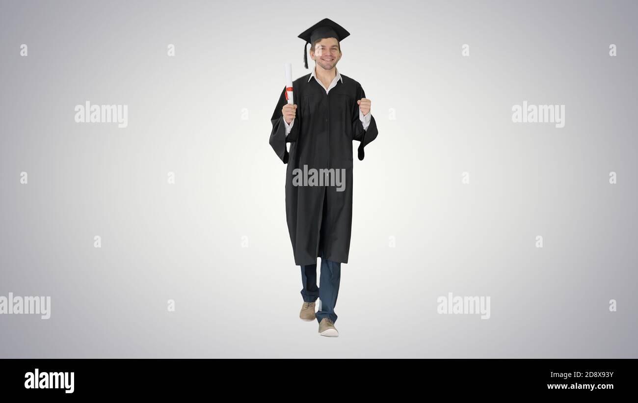 Wide shot. Front view. Happy graduation student walking to the ...