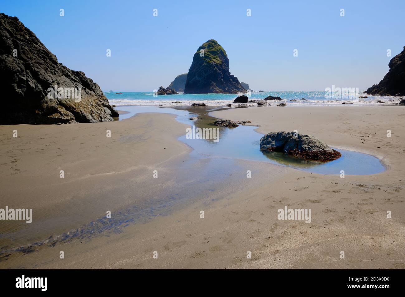 Sunny day with late fog lingering out to sea on Whaleshead Beach in ...