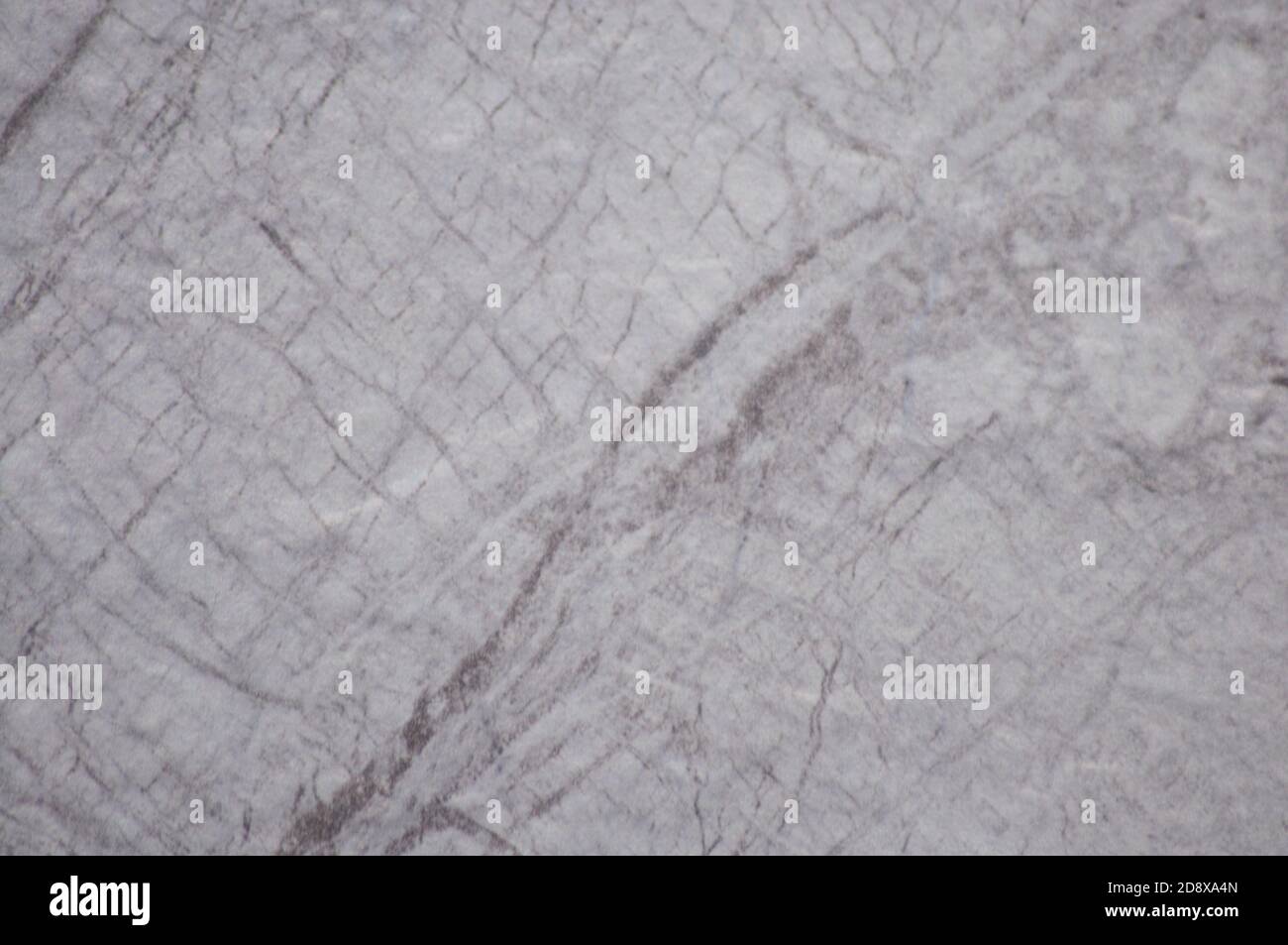 Smoky gray marble with dark veins and blotches, close-up of a flat ...