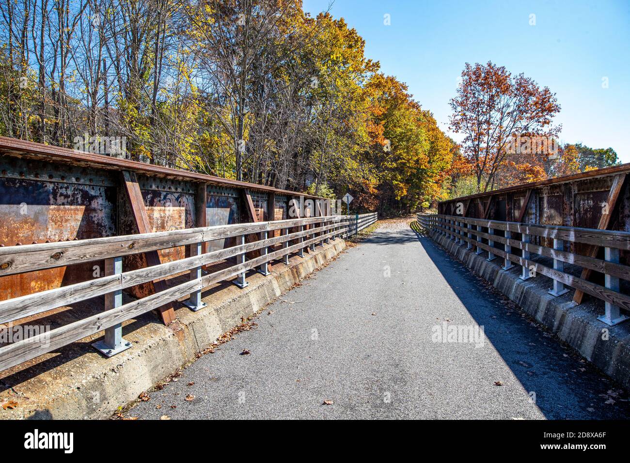 The colors of autumn on an old railway bridge on the Putnam Trailway in ...
