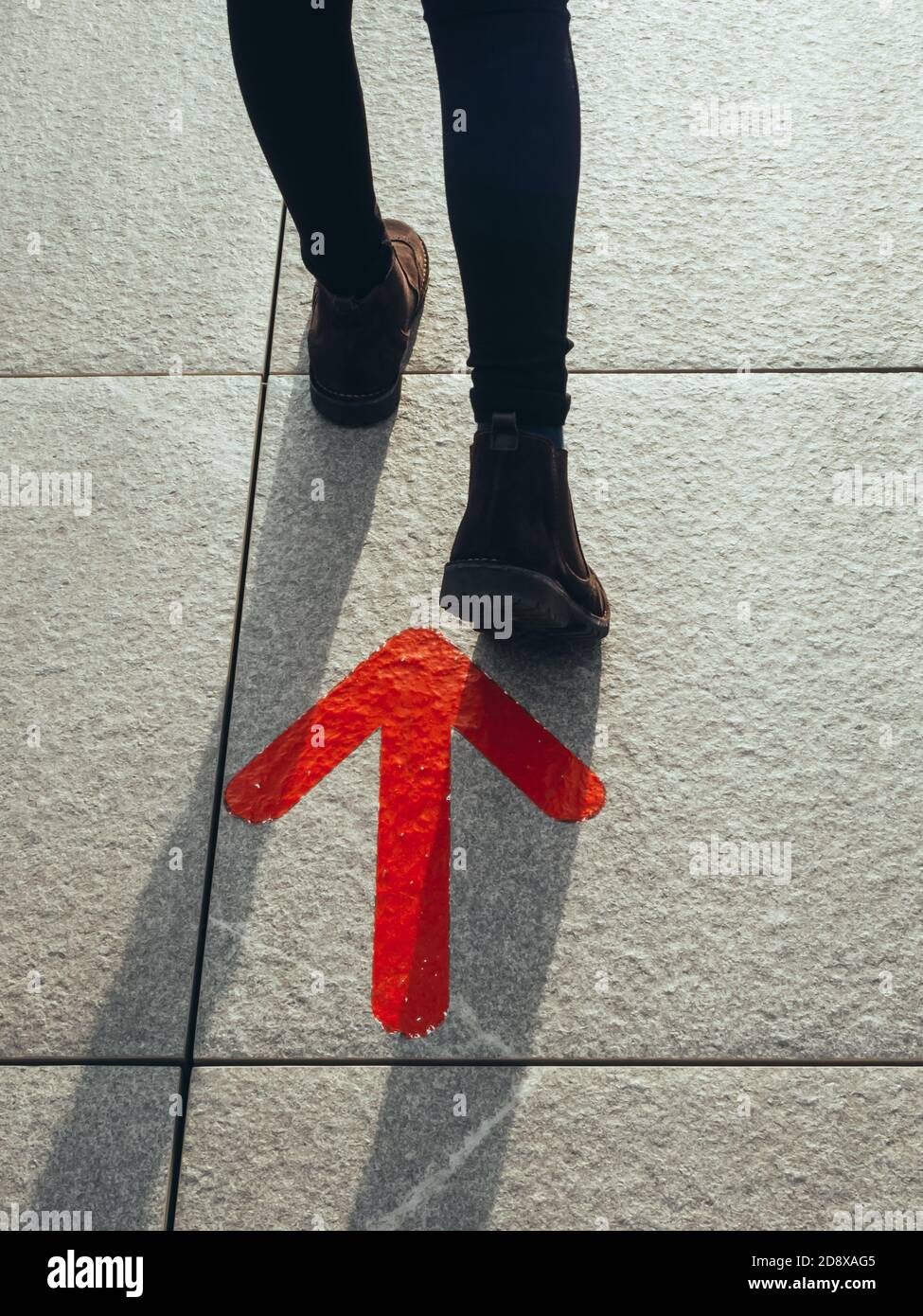 Vertical shot of a person going straight according to the sign Stock ...