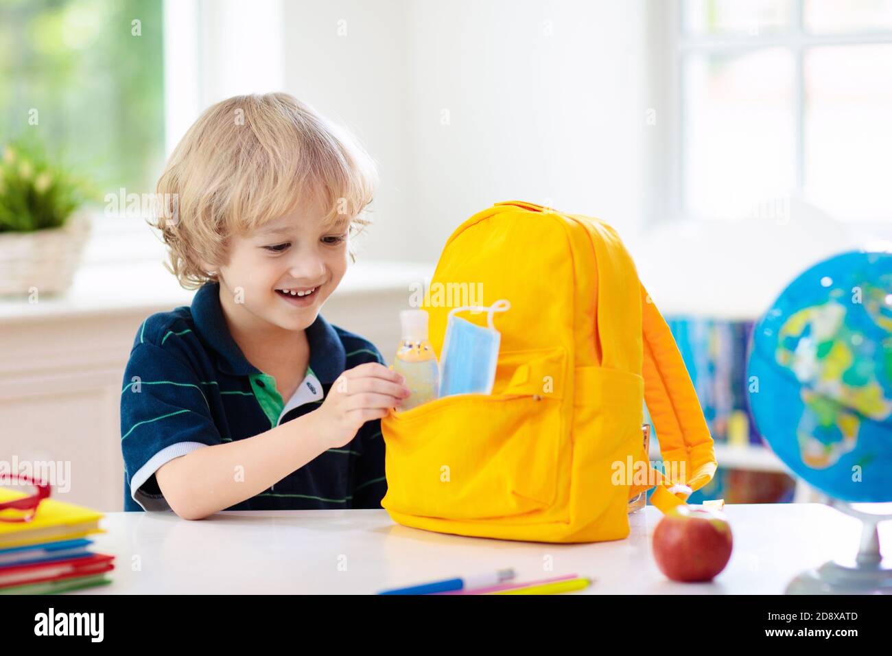 School child with backpack, face mask and sanitizer. Student safety ...