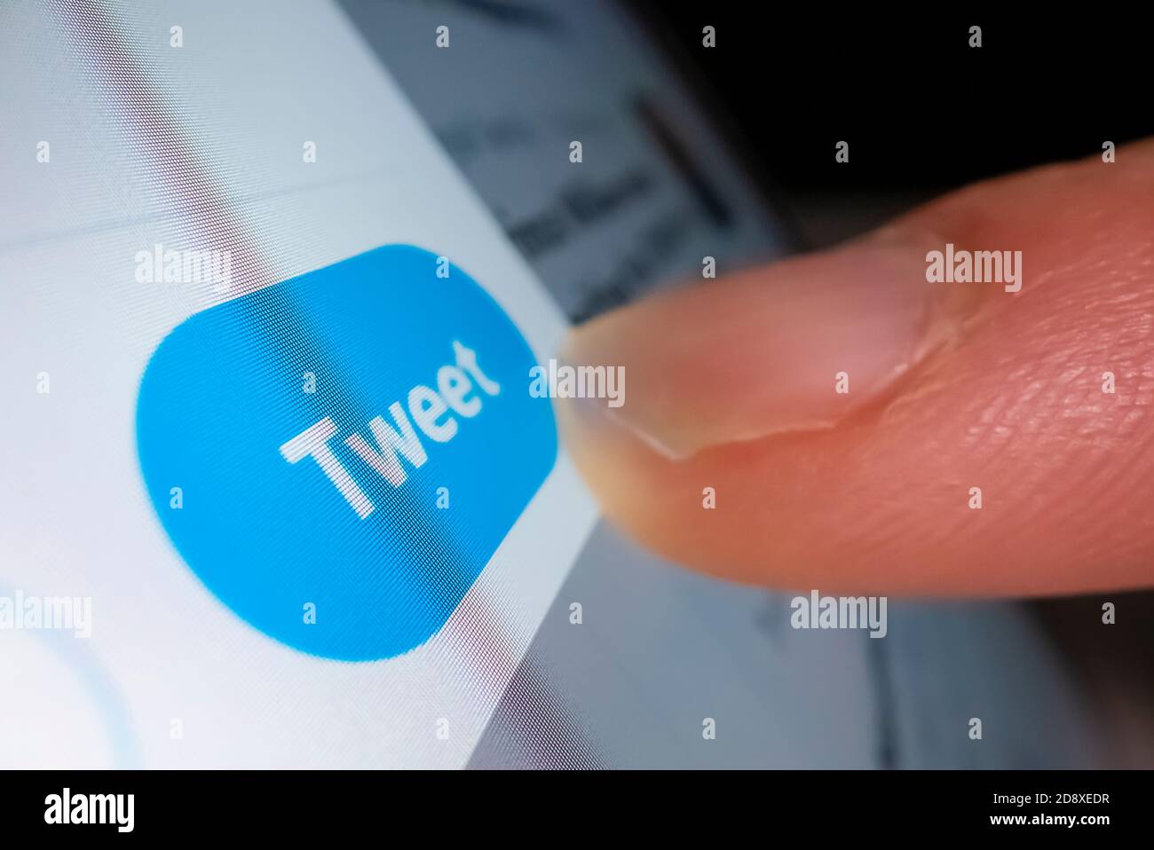 Macro shot of clicking the tweet button in Twitter Stock Photo - Alamy