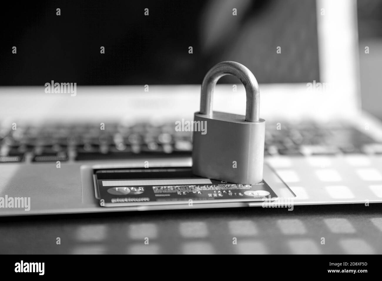 Padlock and credit cards on top of computer keyboard. Internet or cyber ...