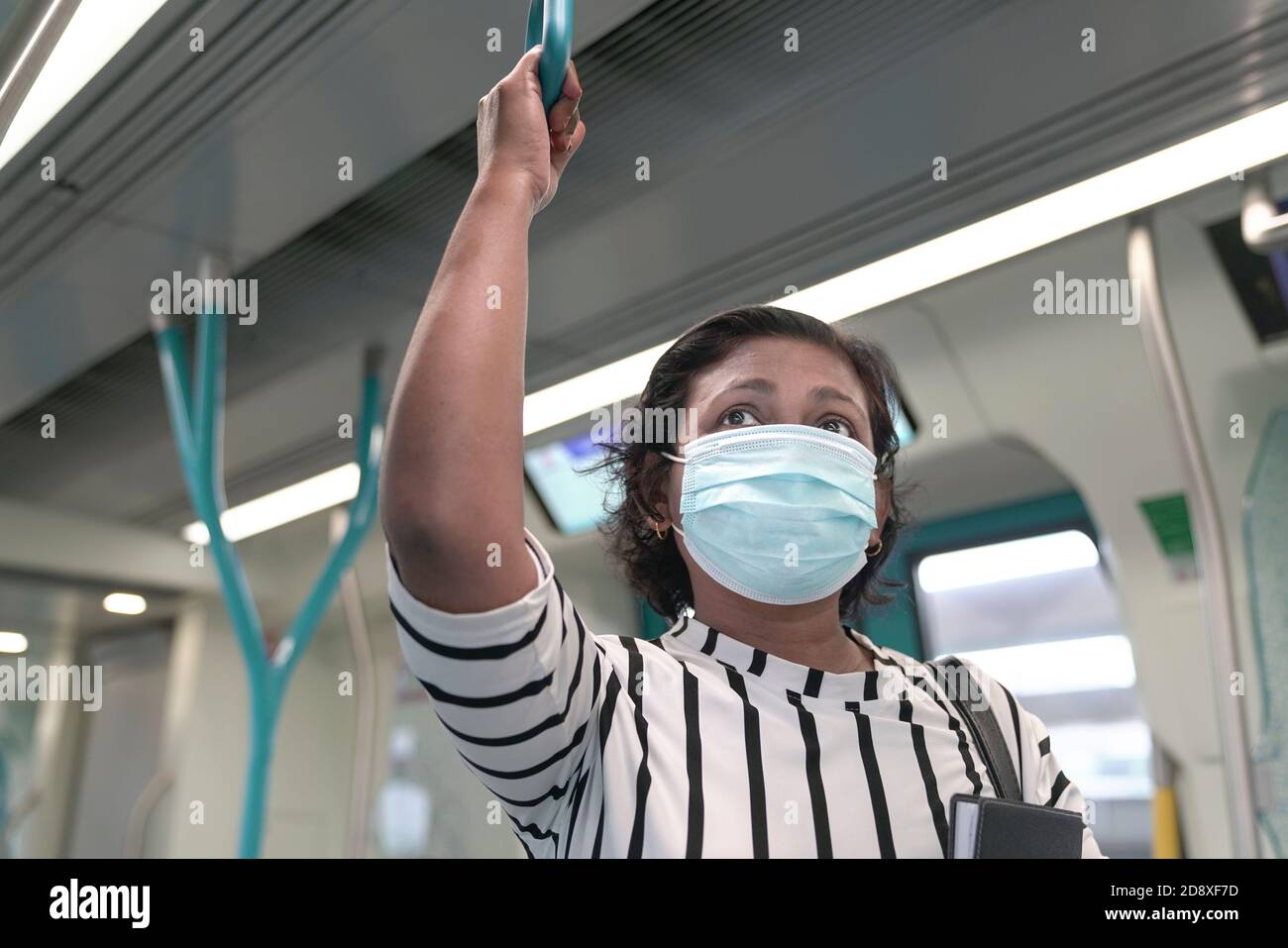 Woman commuter wearing face mask inside train. Travel work pandemic ...