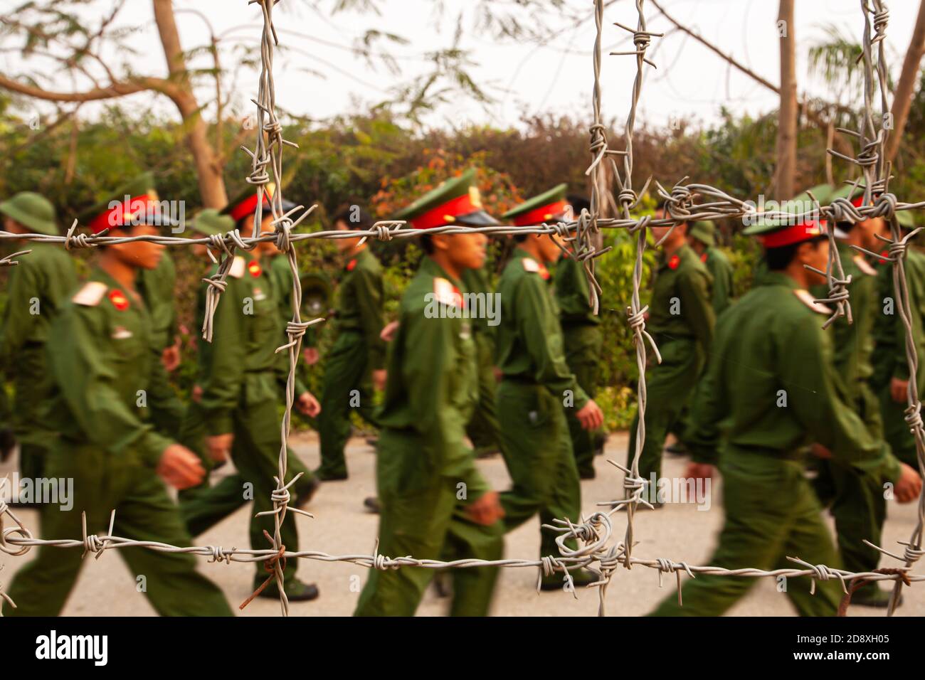 A group of young Vietnamese soldiers training behind barbed wire fence ... A group of young Vietnamese soldiers training behind barbed wire fence ...