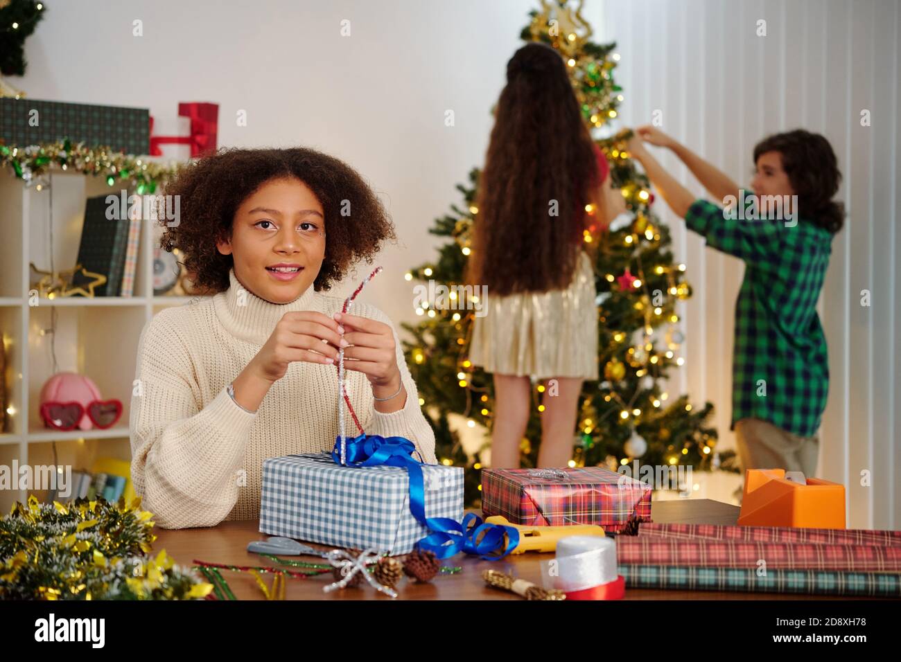 Teenage girl wrapping presents Stock Photo - Alamy