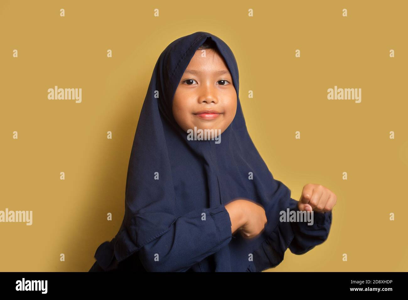 Happy little asian muslim hijab girl dancing Stock Photo - Alamy