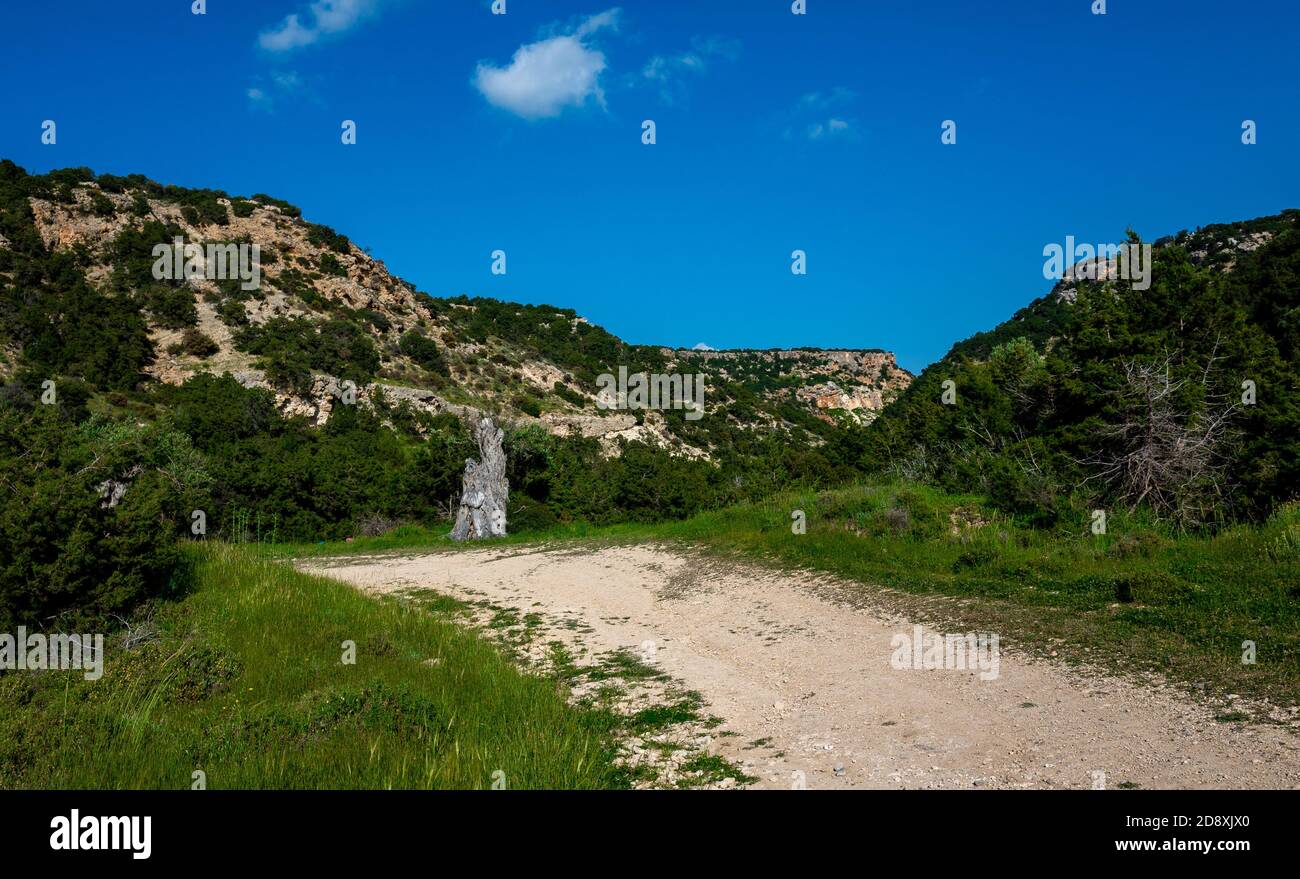 Sandy mountain road of the island of Cyprus in the light of the setting ...