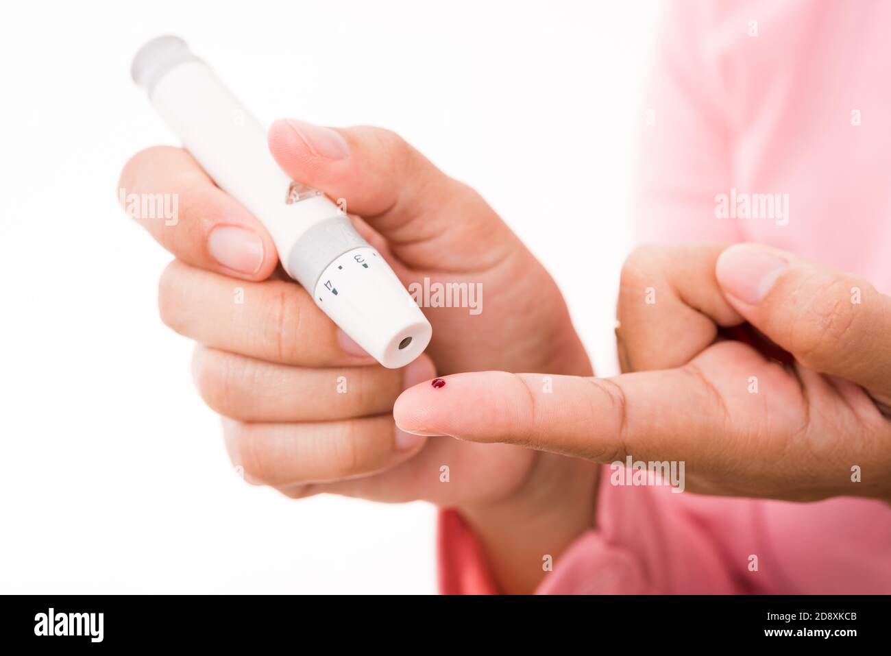Closeup woman measuring glucose level using a hand test lancelet on the ...