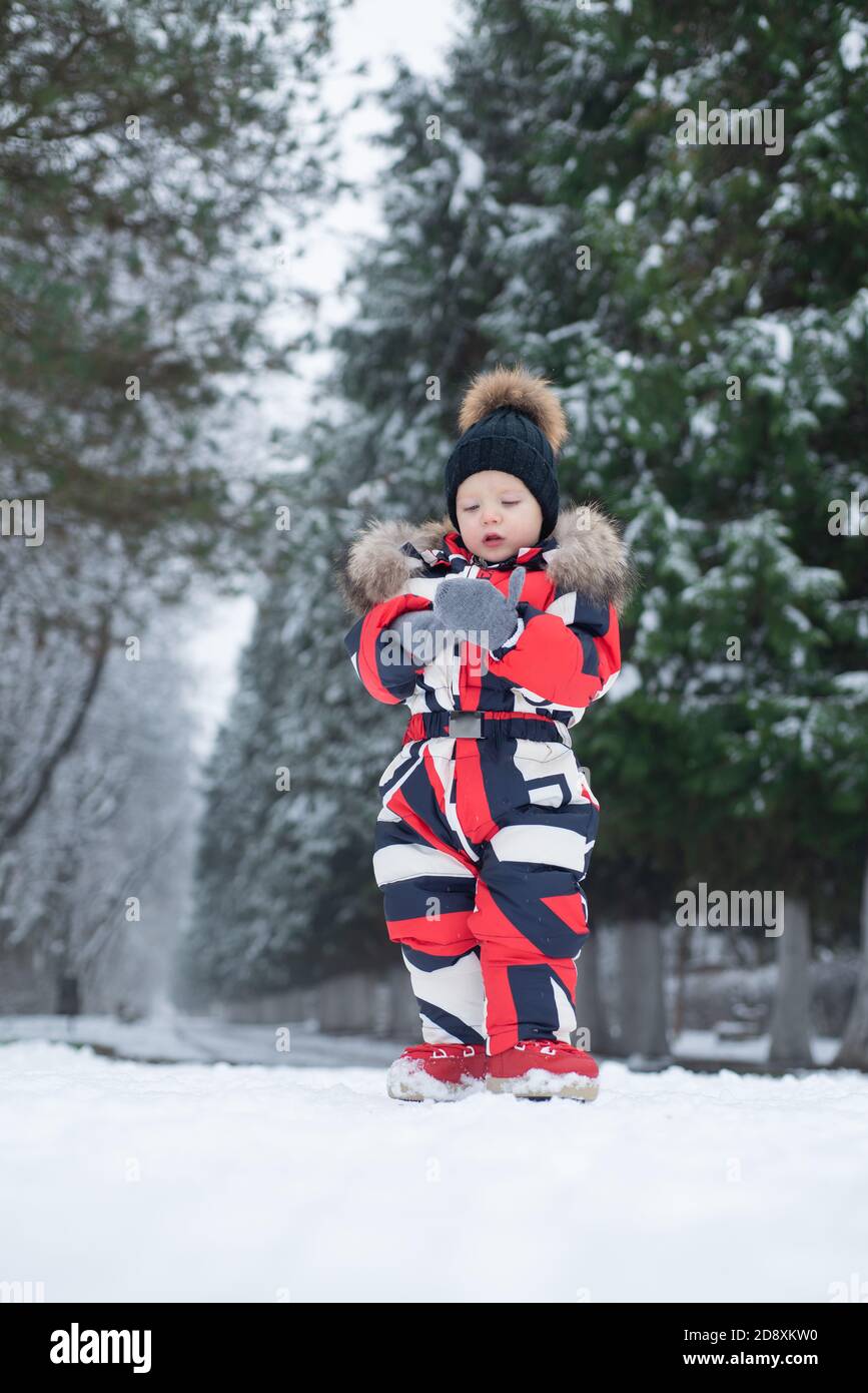 Kid walks outdoors and enjoy walking. Winter. Cute young boy. Child in ...