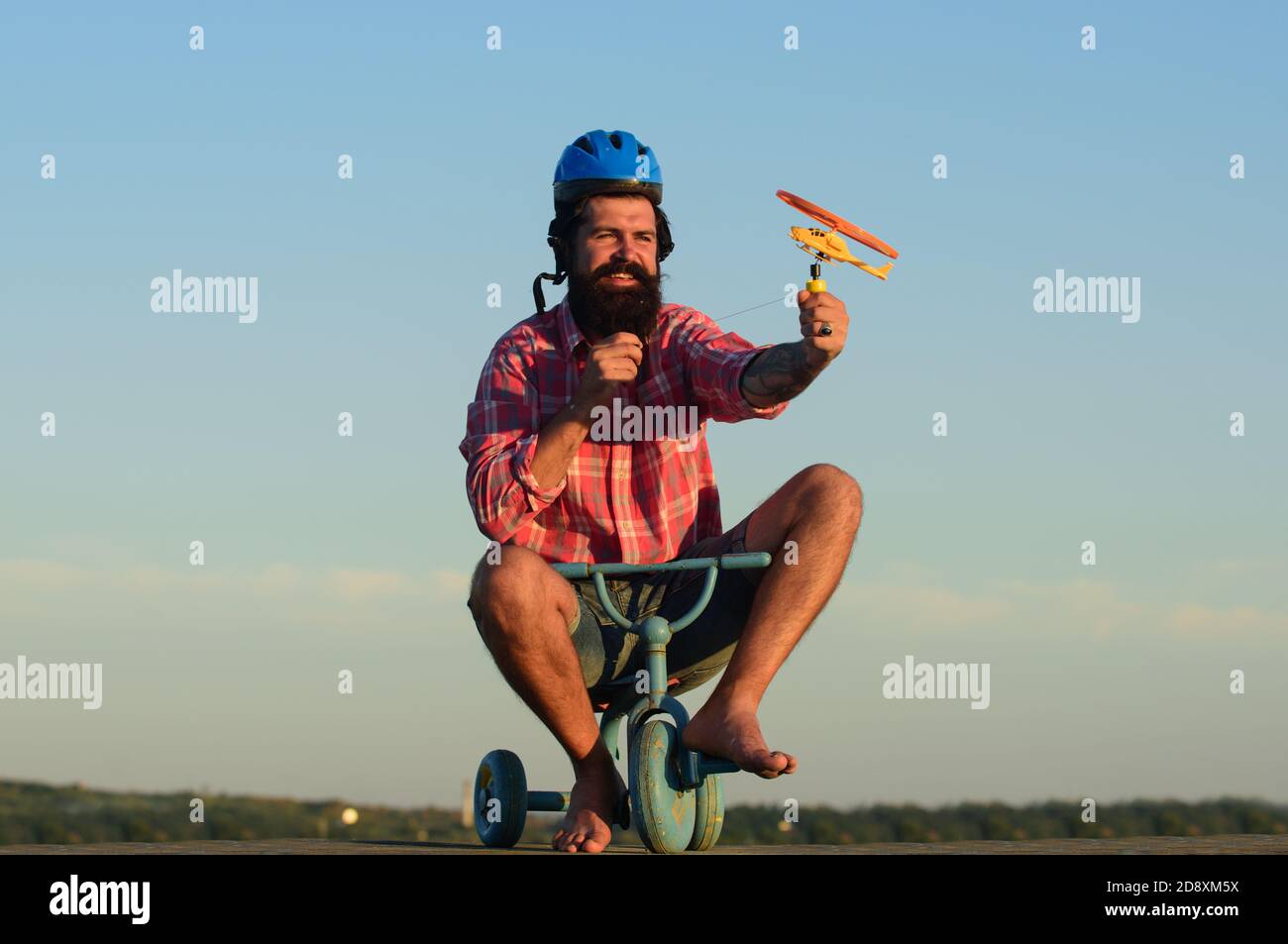 Childhood memory. Crazy Young man riding three wheeled bicycle Stock ...