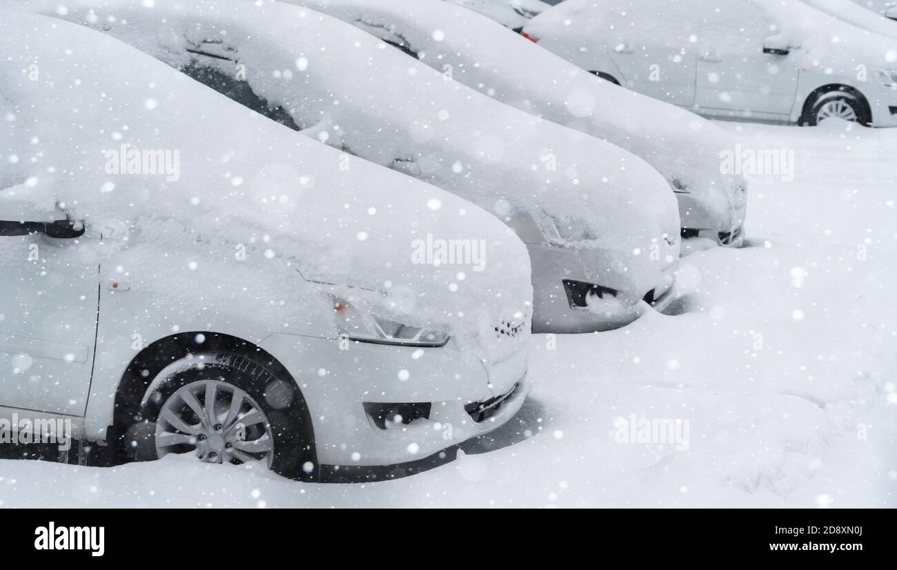 Parked cars covered with snow. Winter season Stock Photo - Alamy