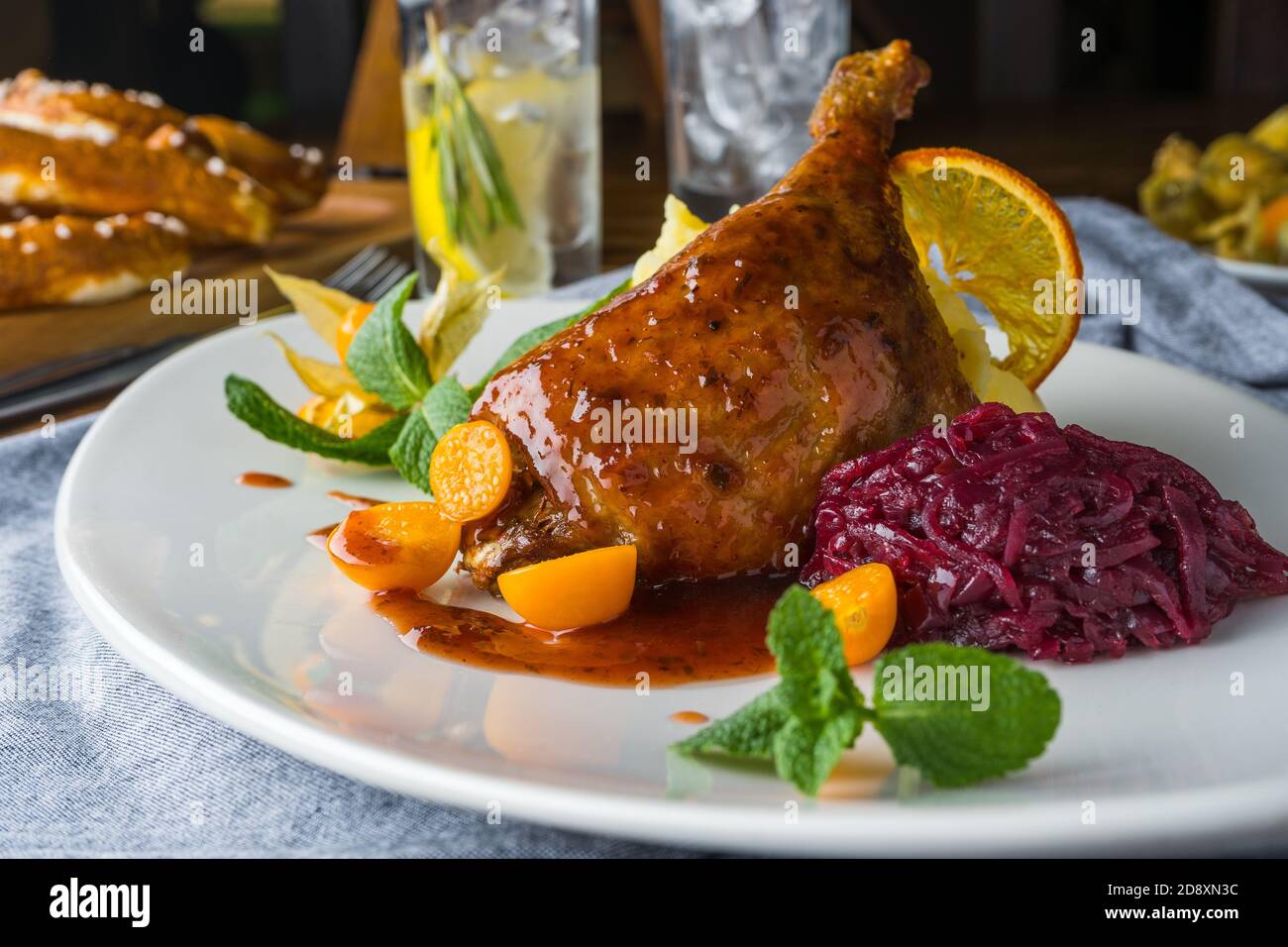 Duck leg on a rustic table in a cozy pub Stock Photo - Alamy