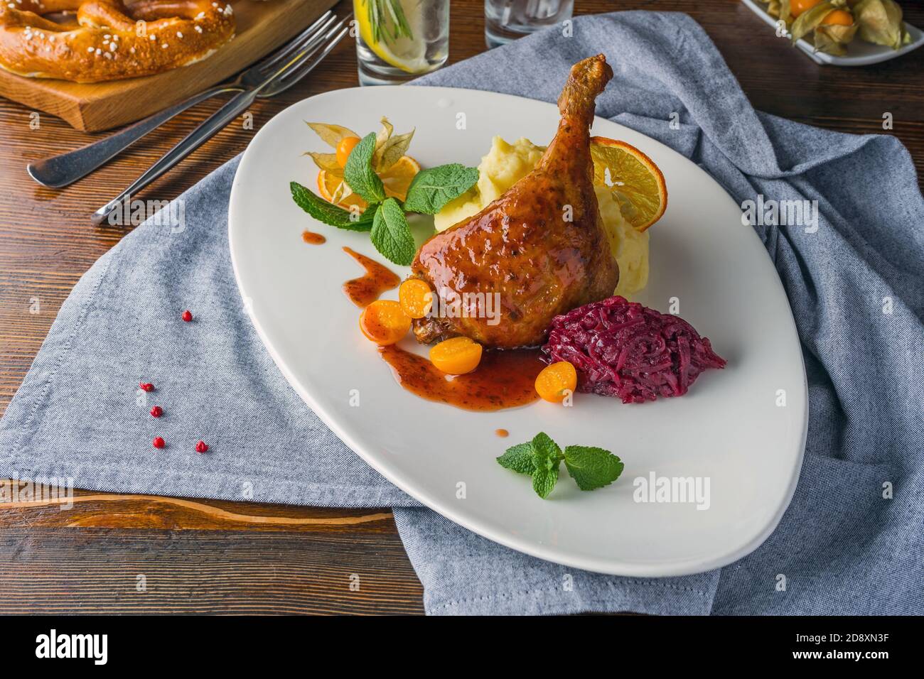 Duck leg on a rustic table in a cozy pub Stock Photo - Alamy