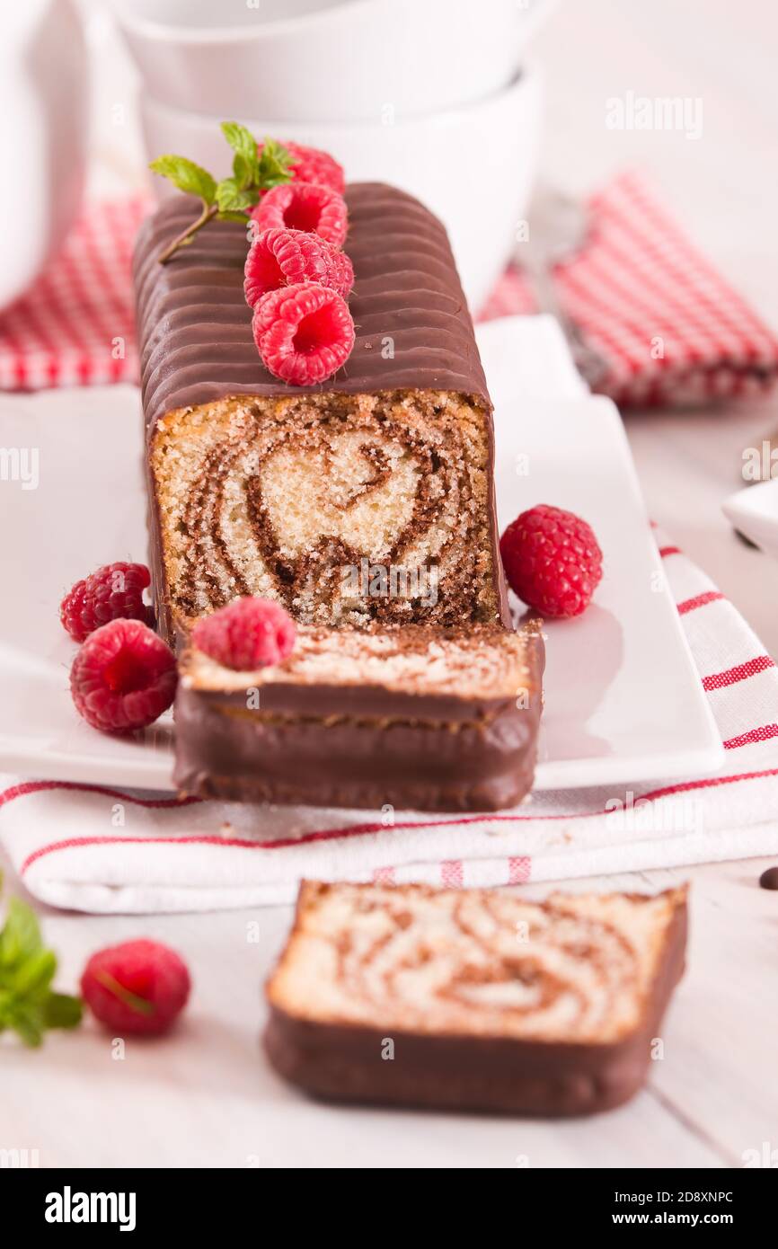 Marble cake with raspberries Stock Photo - Alamy