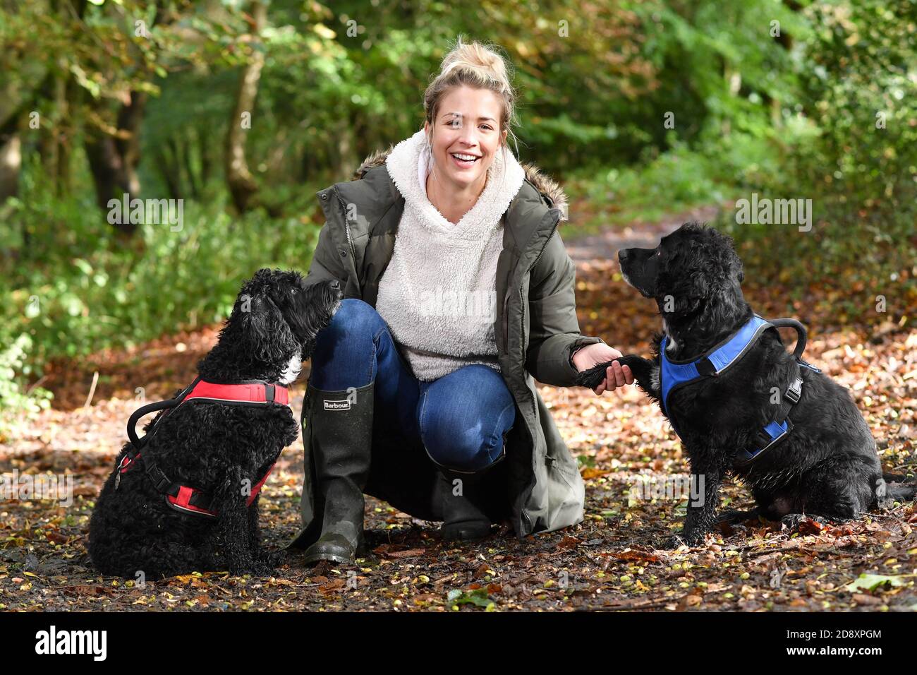 EDITORIAL USE ONLY Gemma Atkinson walks her dogs Sproodle Norman (left ...