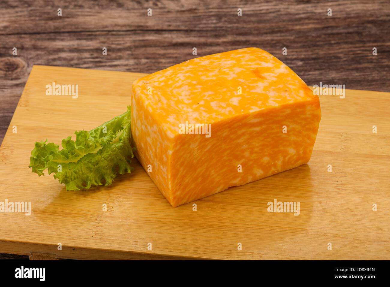 Dairy Marble cheese brick over board Stock Photo - Alamy