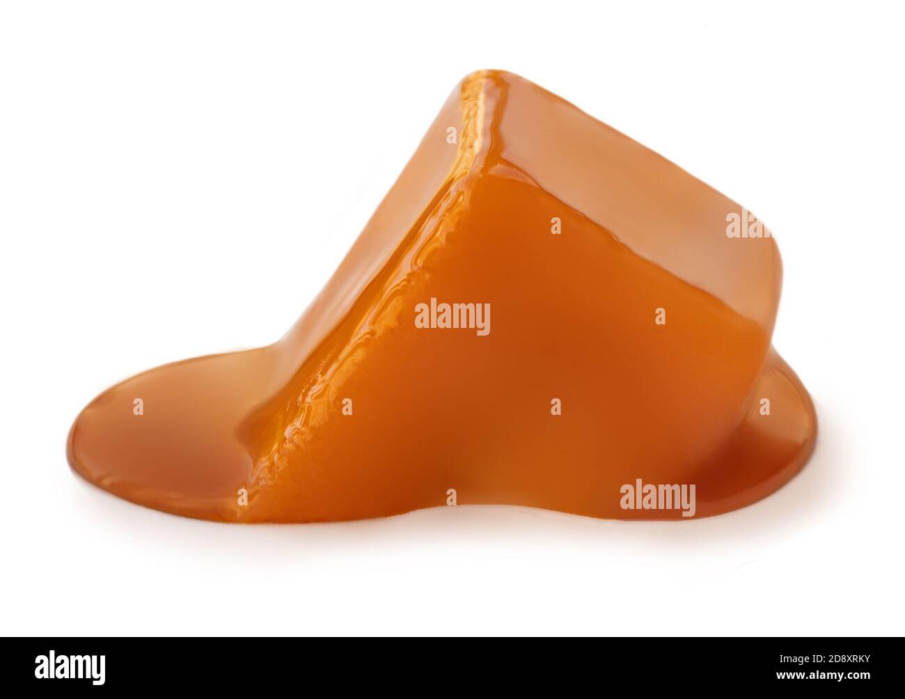 Homemade caramel piece and flowing sauce isolated on white background ...