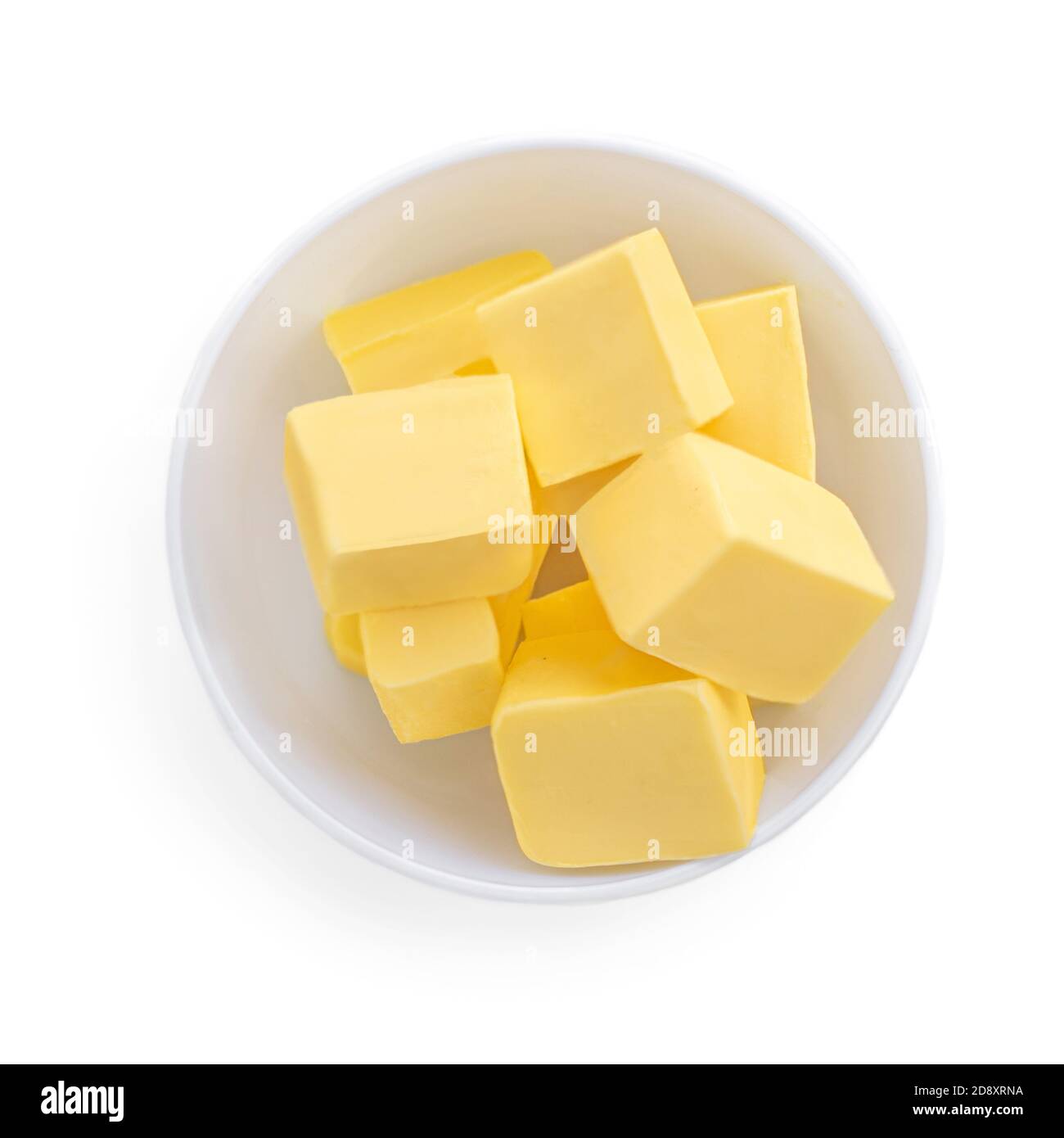 Butter pieces in bowl isolated on white background, top view. Fresh ...