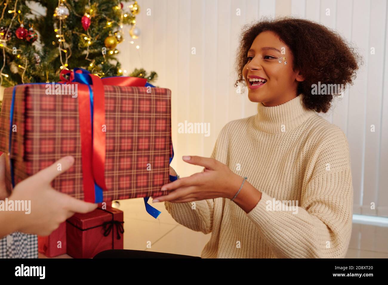 Teenage girl accepting present Stock Photo - Alamy