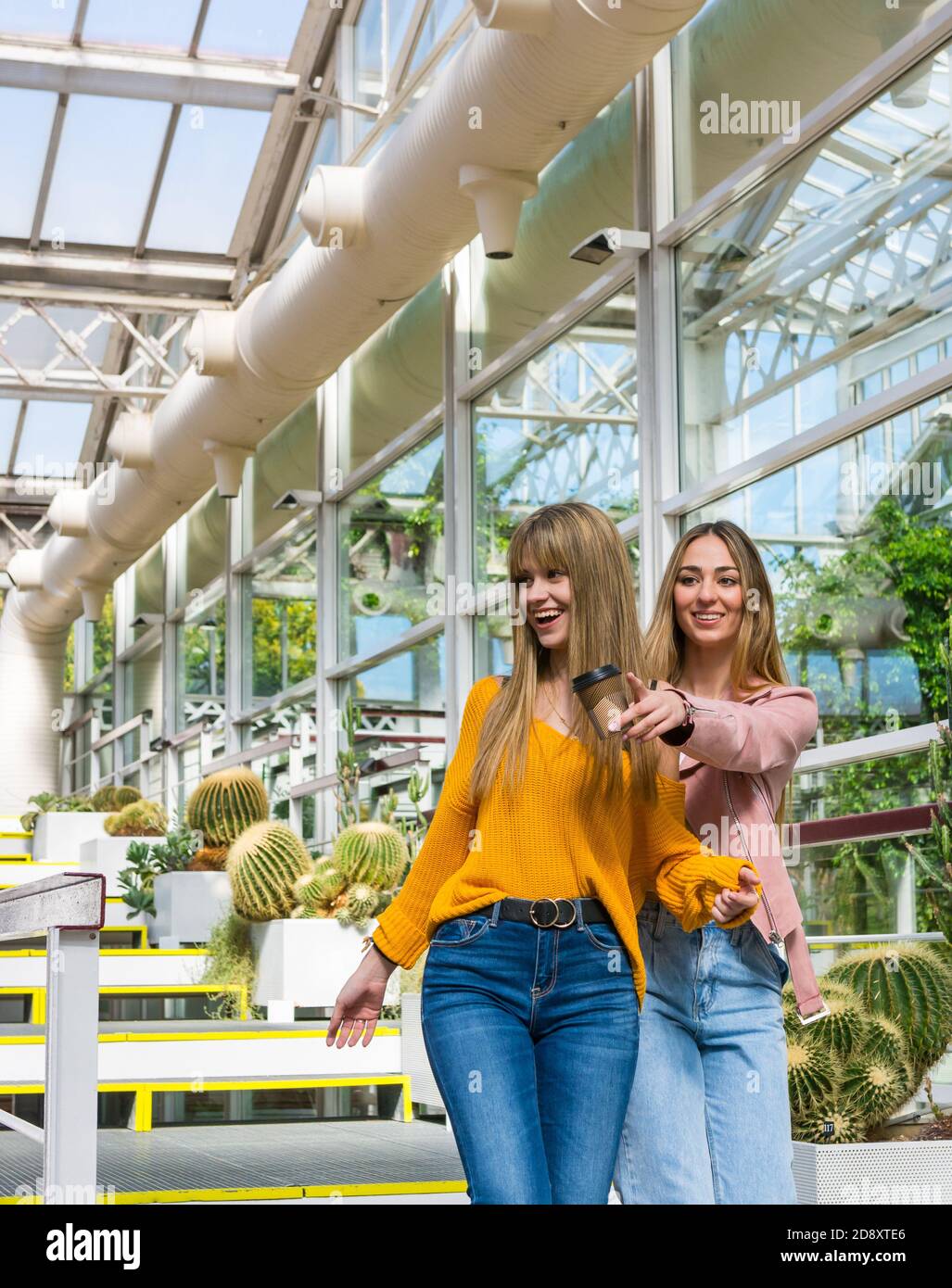 Two friends walk through a park and tell each other their secrets while ...